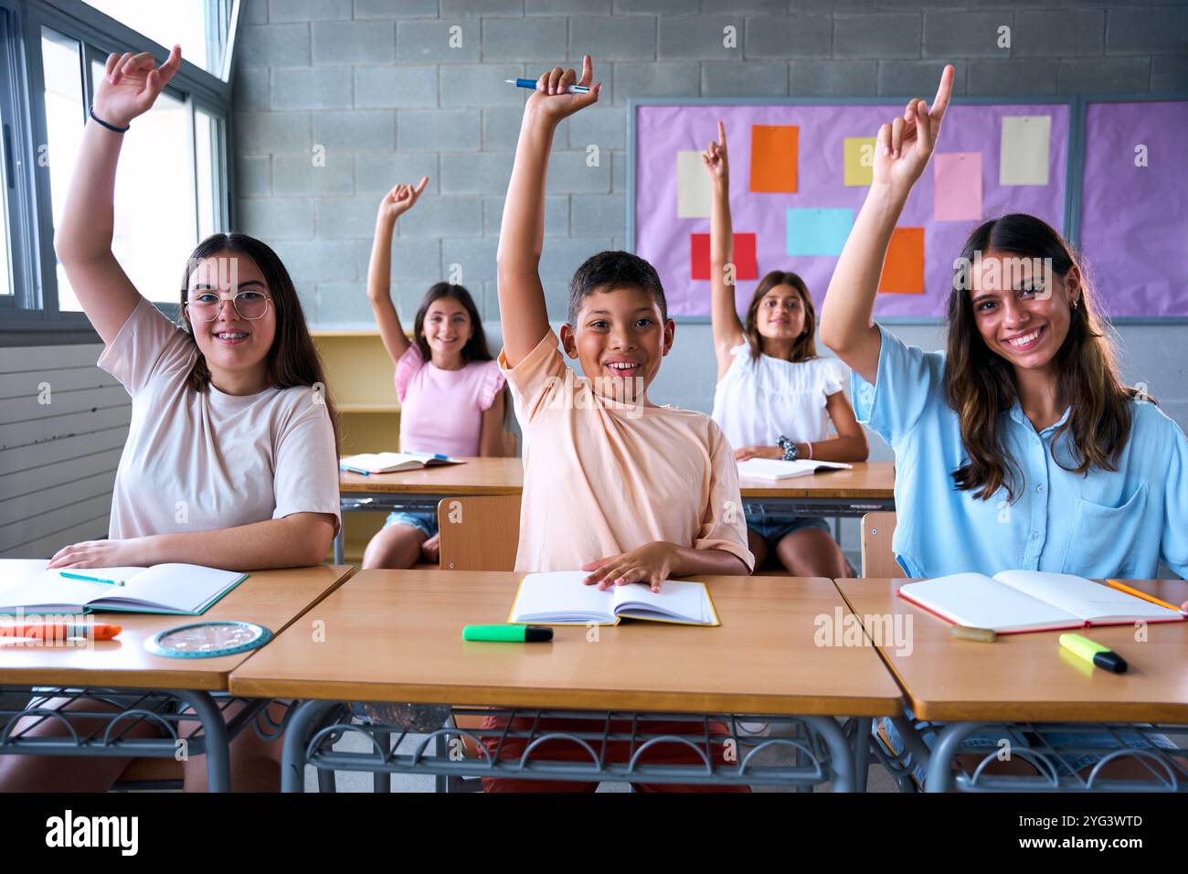 Portrait of happy group diverse elementary school students sitting in ...
