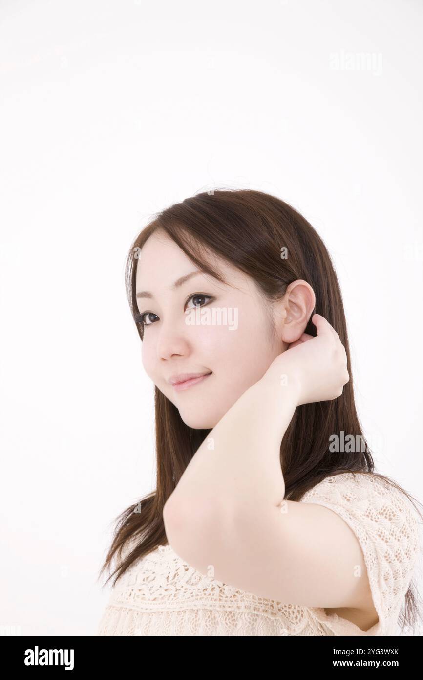 Woman brushing up her hair Stock Photo - Alamy
