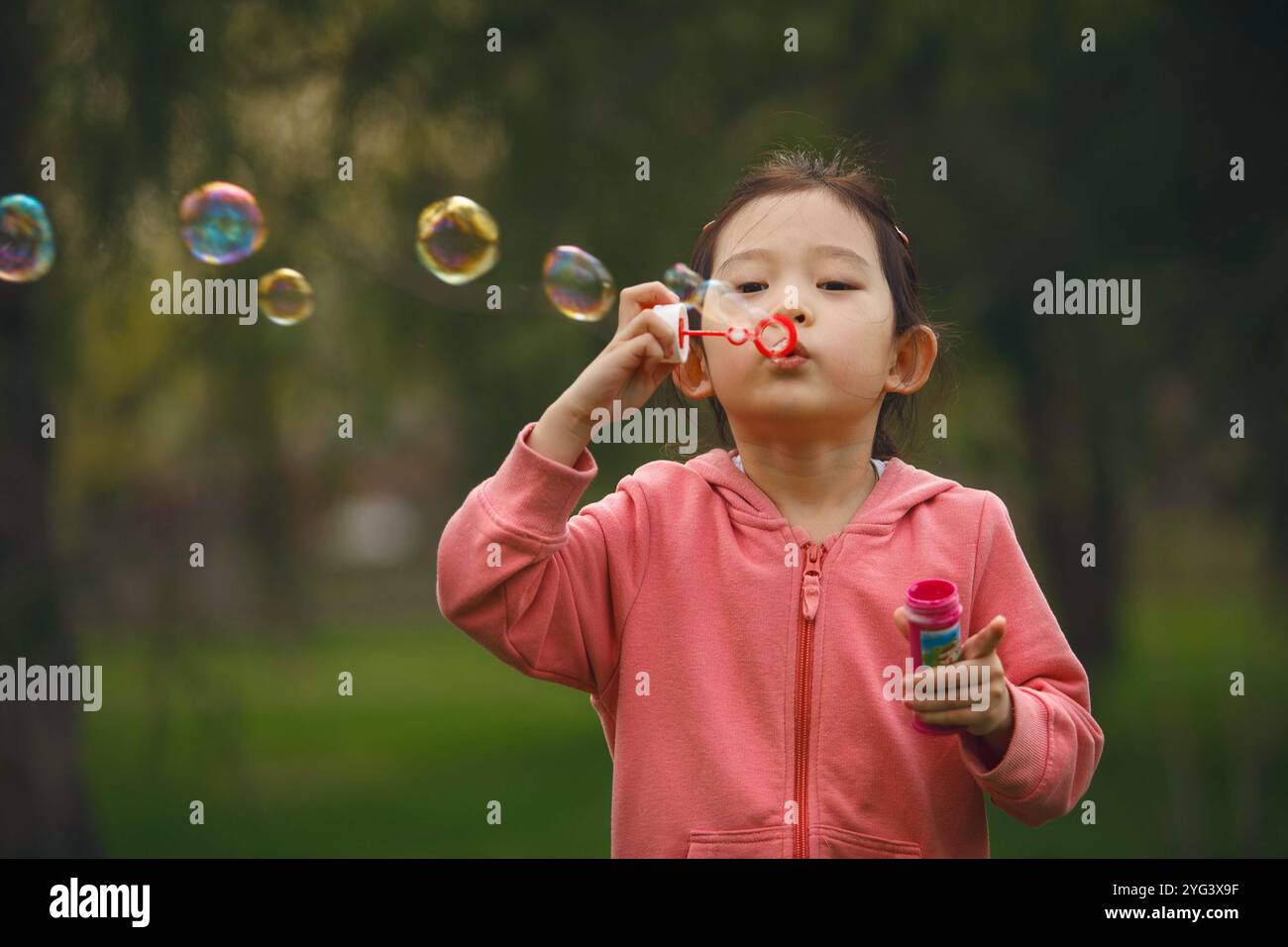 Joyful friends blowing bubbles hi-res stock photography and images - Alamy
