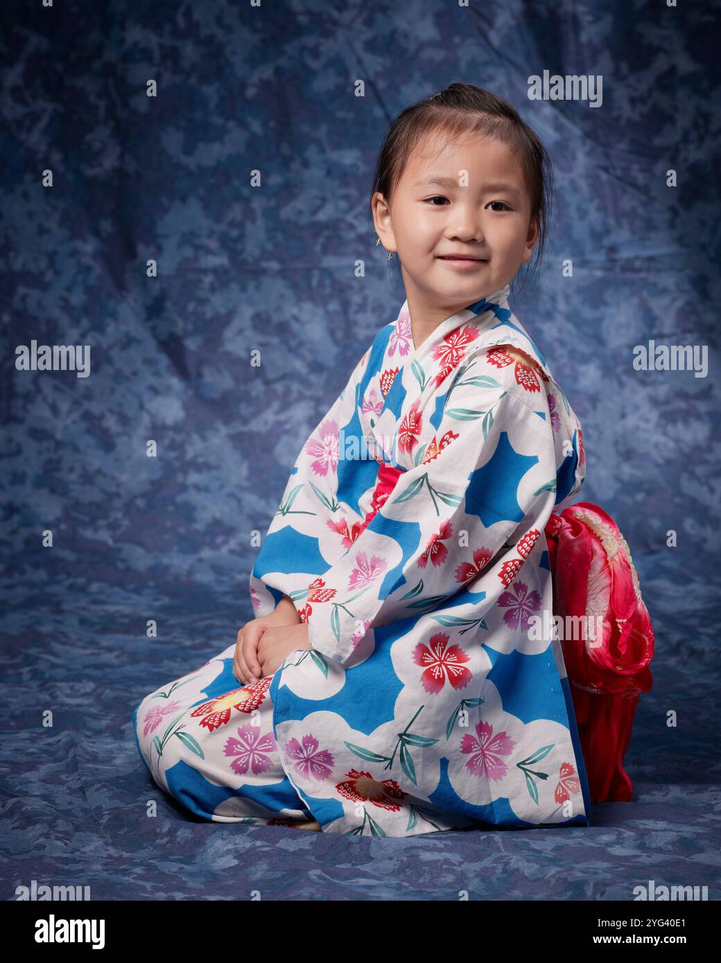 Girl in yukata sitting upright on her side looking straight ahead Stock ...