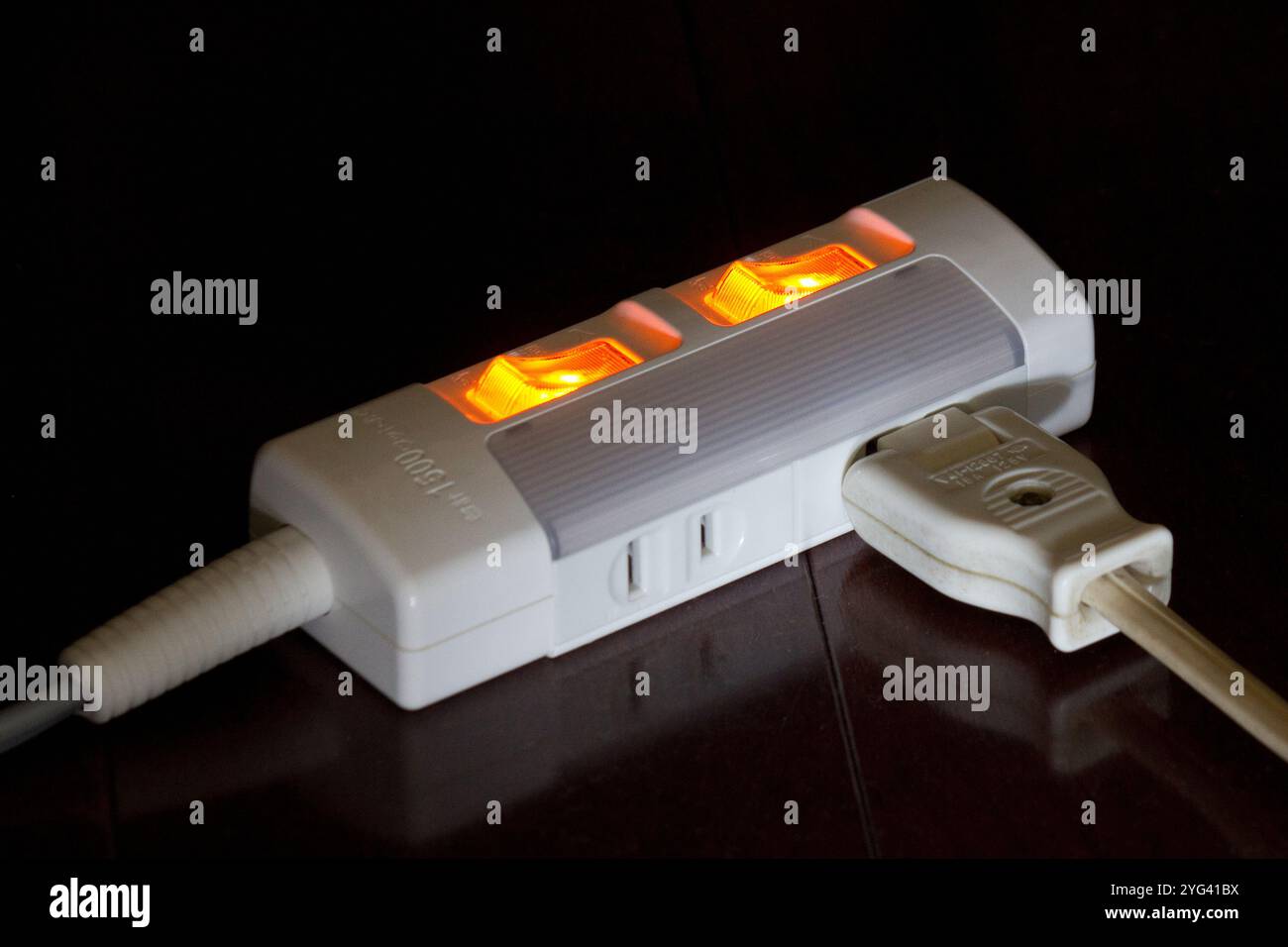 Extension socket in dark room Stock Photo - Alamy