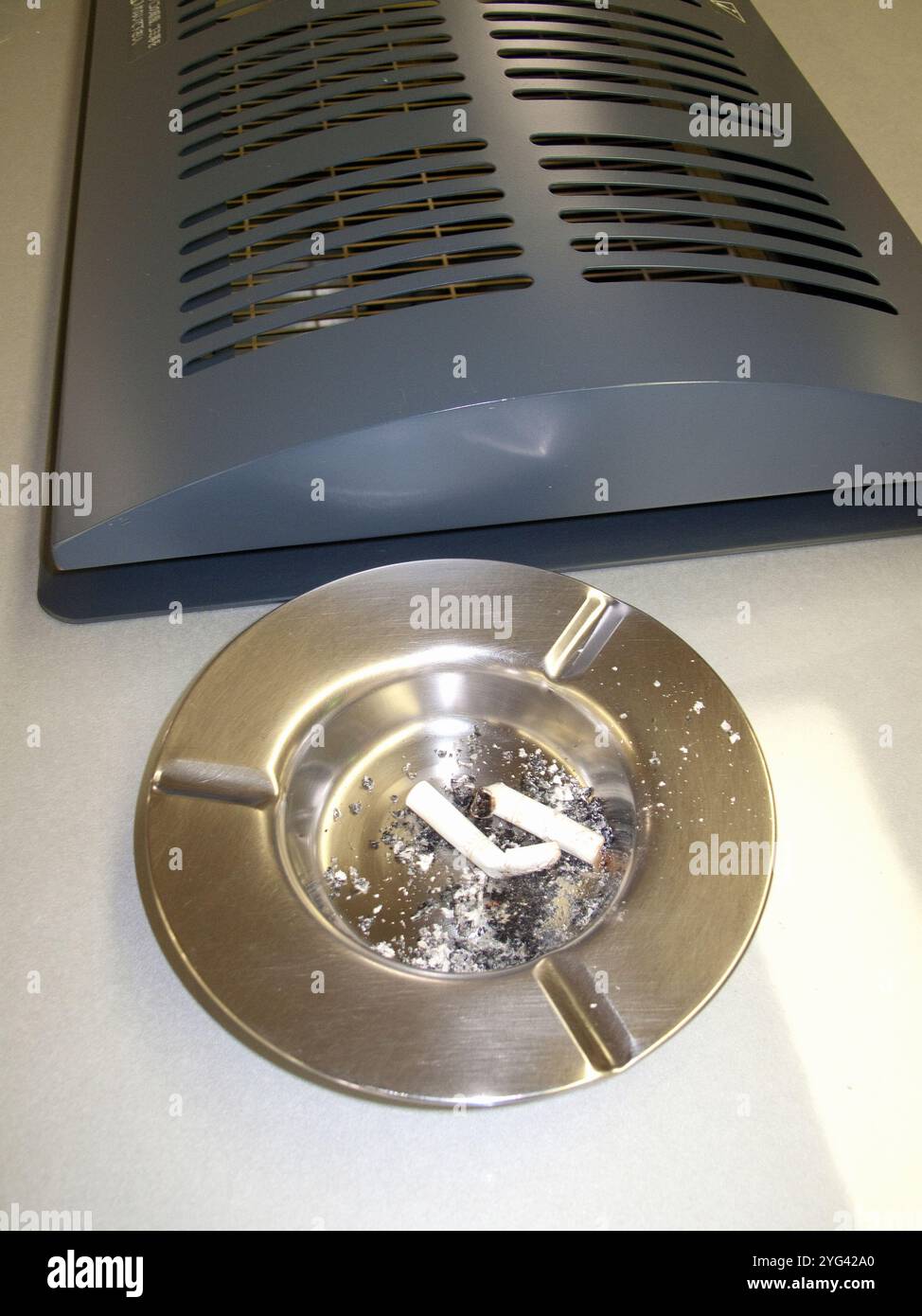 Smoking area with smoke evacuators and ashtrays Stock Photo - Alamy