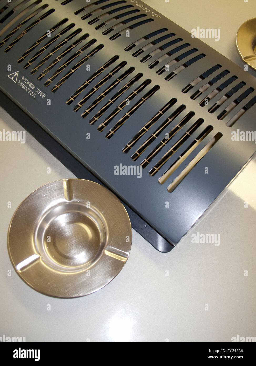 Smoking area with smoke evacuators and ashtrays Stock Photo - Alamy