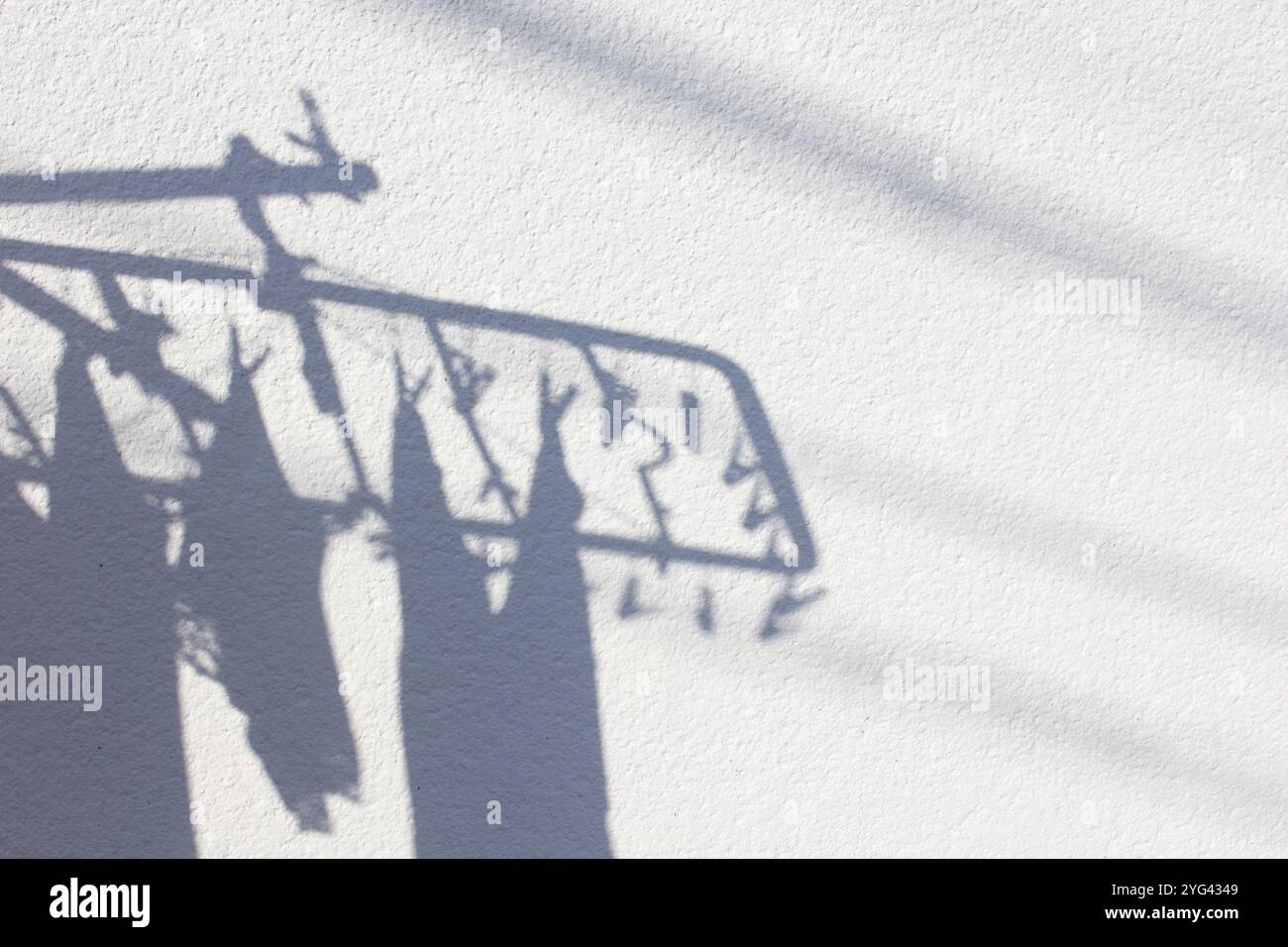 Laundry shadows on white wall Stock Photo - Alamy