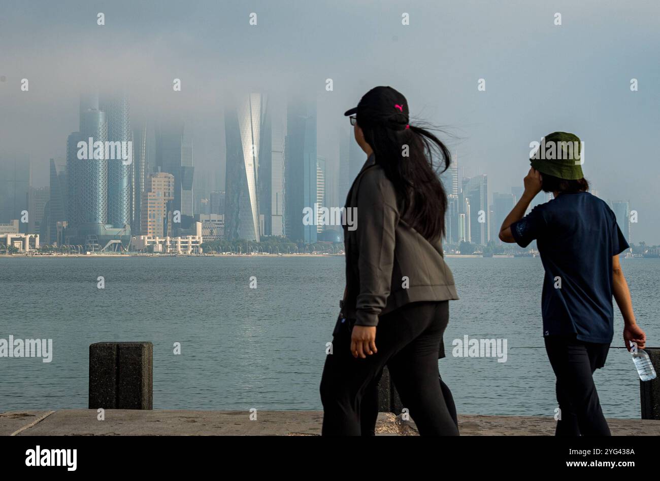 Foggy day in Doha People walk along the Doha Corniche in heavy fog on ...