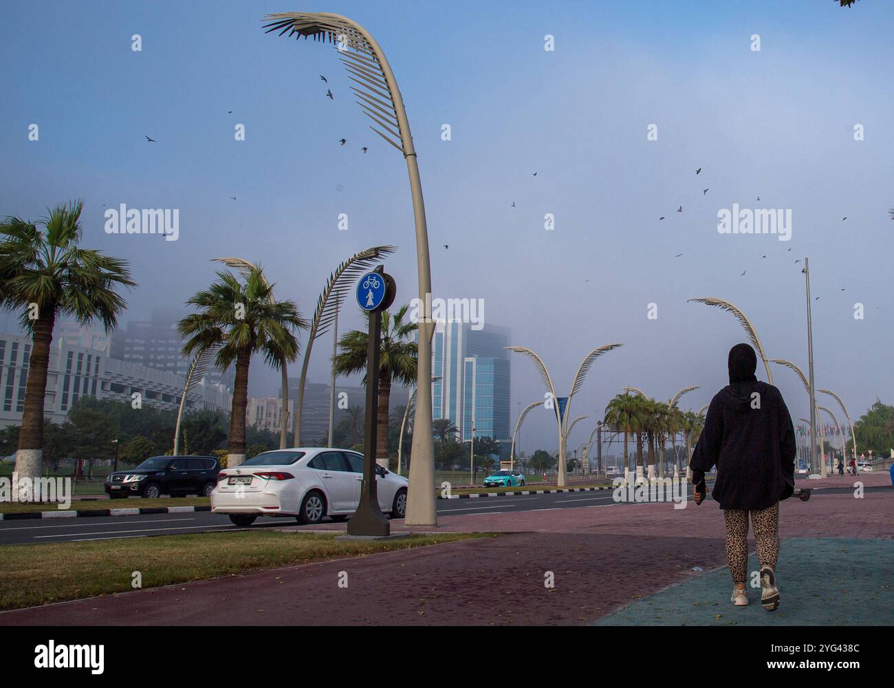 Foggy day in Doha People walk along the Doha Corniche in heavy fog on ...