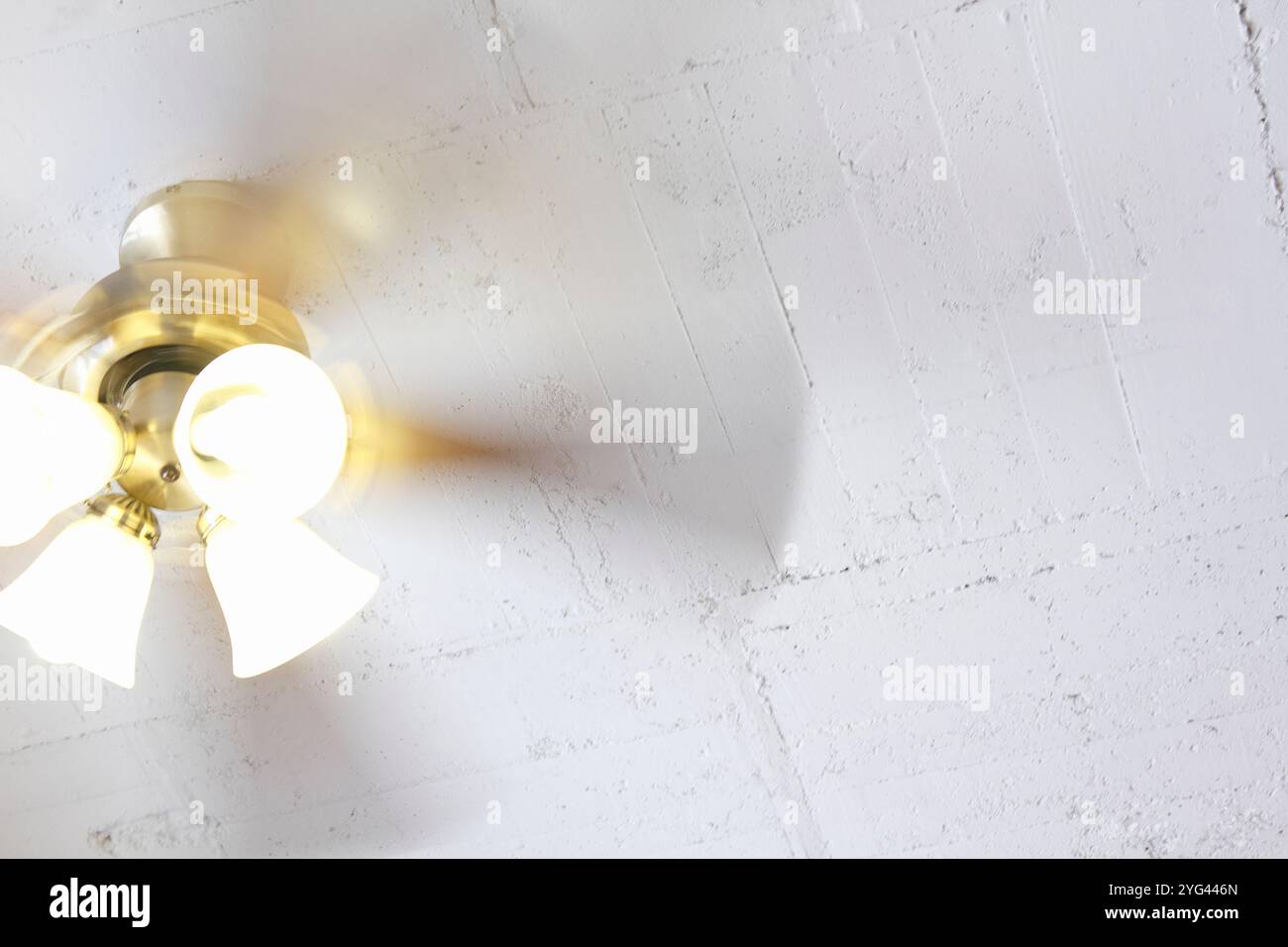 Rotating room ceiling fan Stock Photo - Alamy