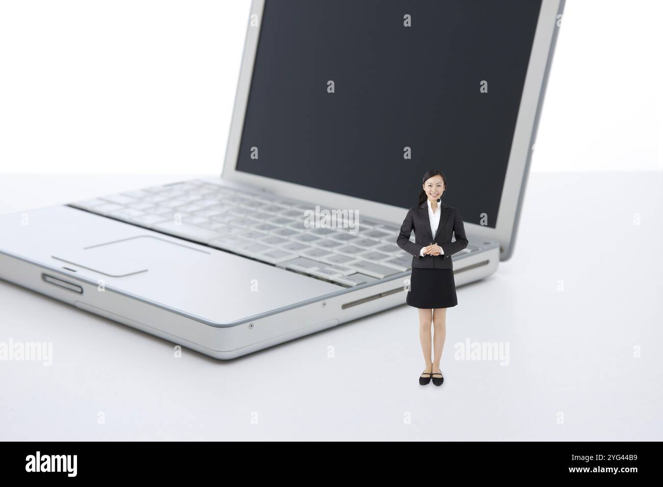 Operator standing in front of laptop Stock Photo - Alamy