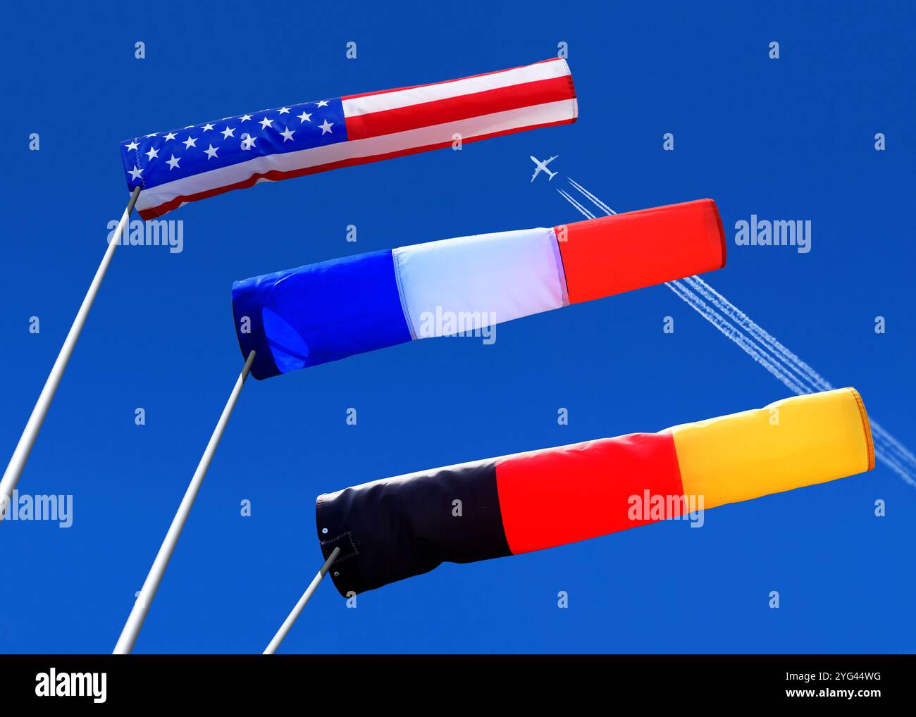 three windsocks in strong winds, in the colours of the national flags ...