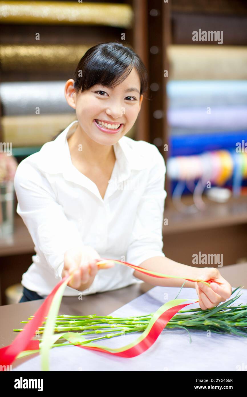 Female florist shop assistant Stock Photo - Alamy