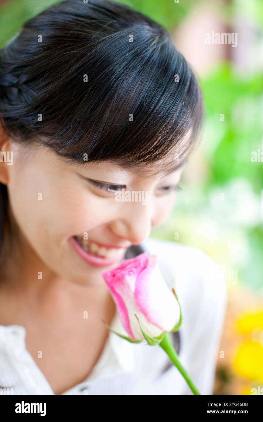 Woman smelling roses hi-res stock photography and images - Alamy