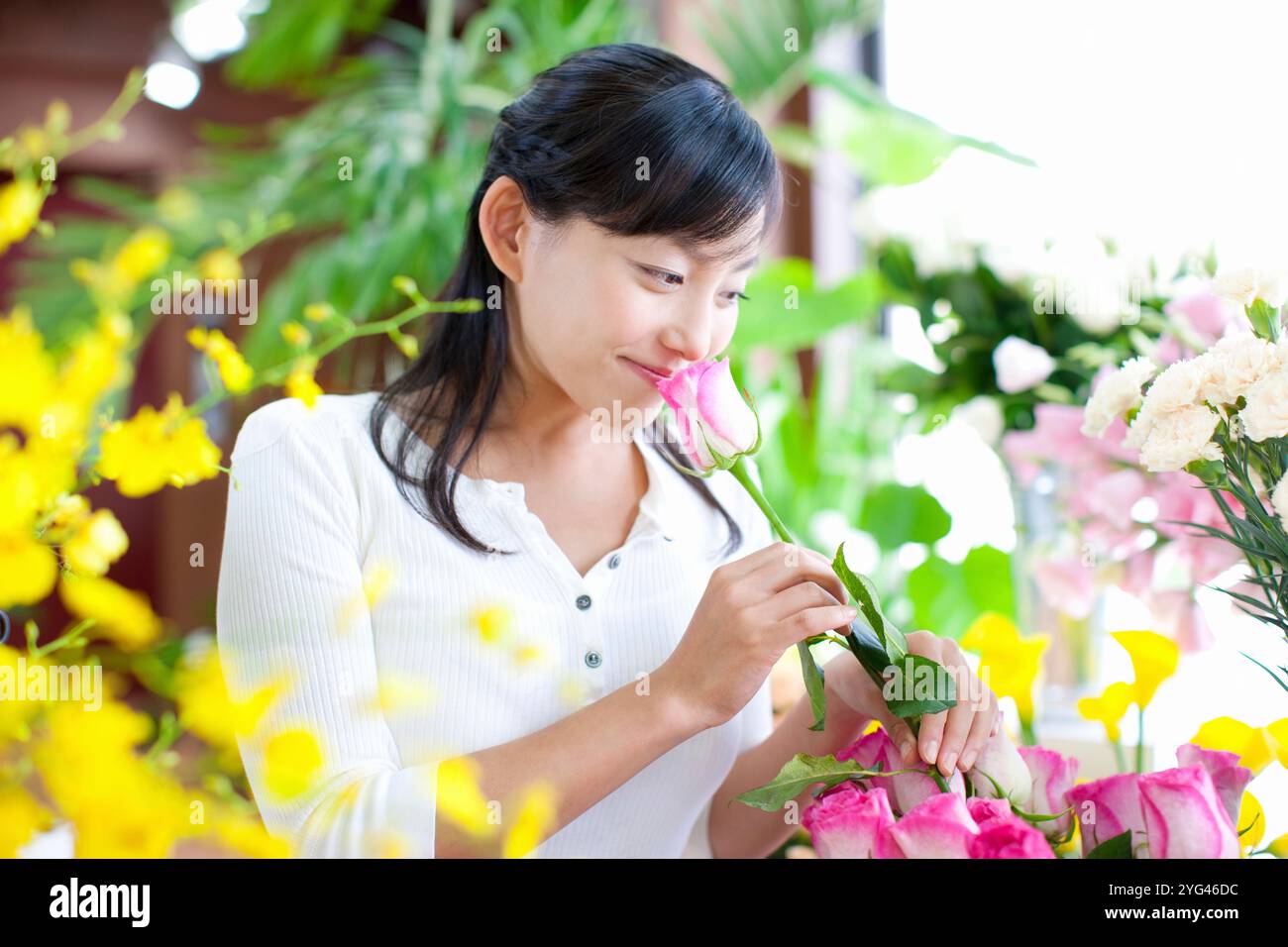 Woman smelling white rose hi-res stock photography and images - Alamy