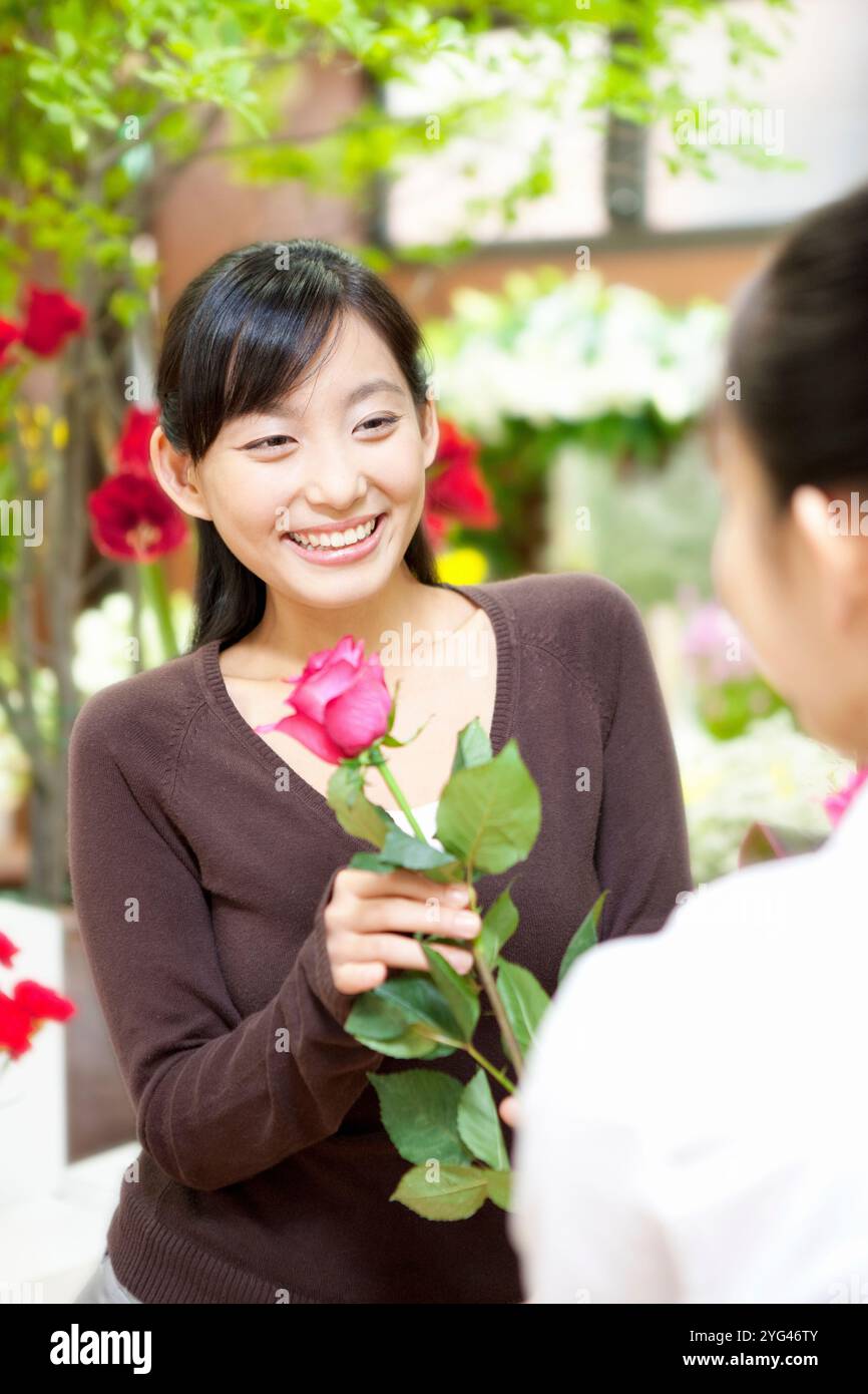 Woman receiving rose petals Stock Photo - Alamy