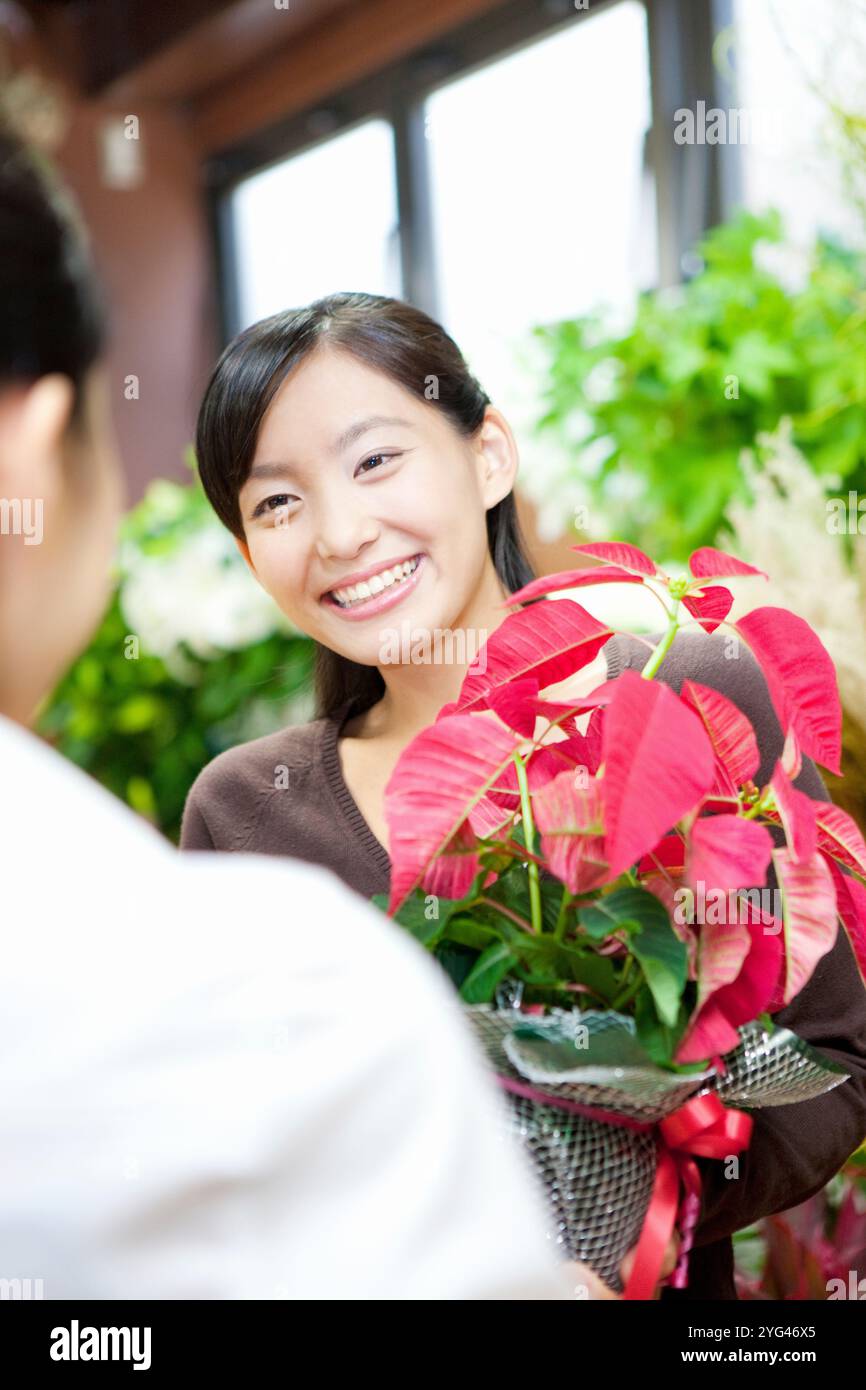 Woman receiving flower hi-res stock photography and images - Alamy