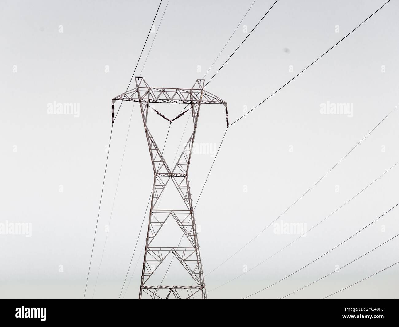 Tall power electricity industrial grid line pylon stands against a ...
