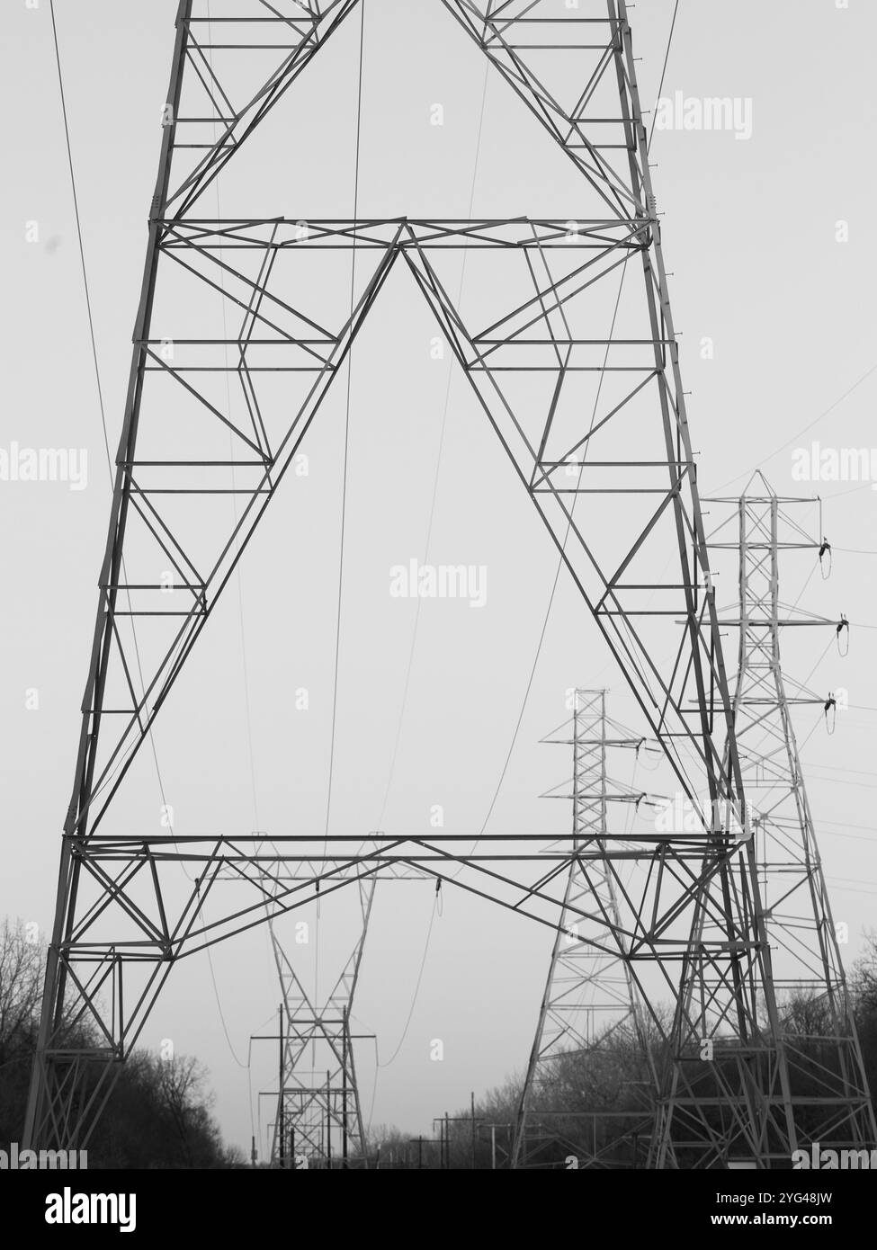 Tall power electricity industrial grid line pylon stands against a ...
