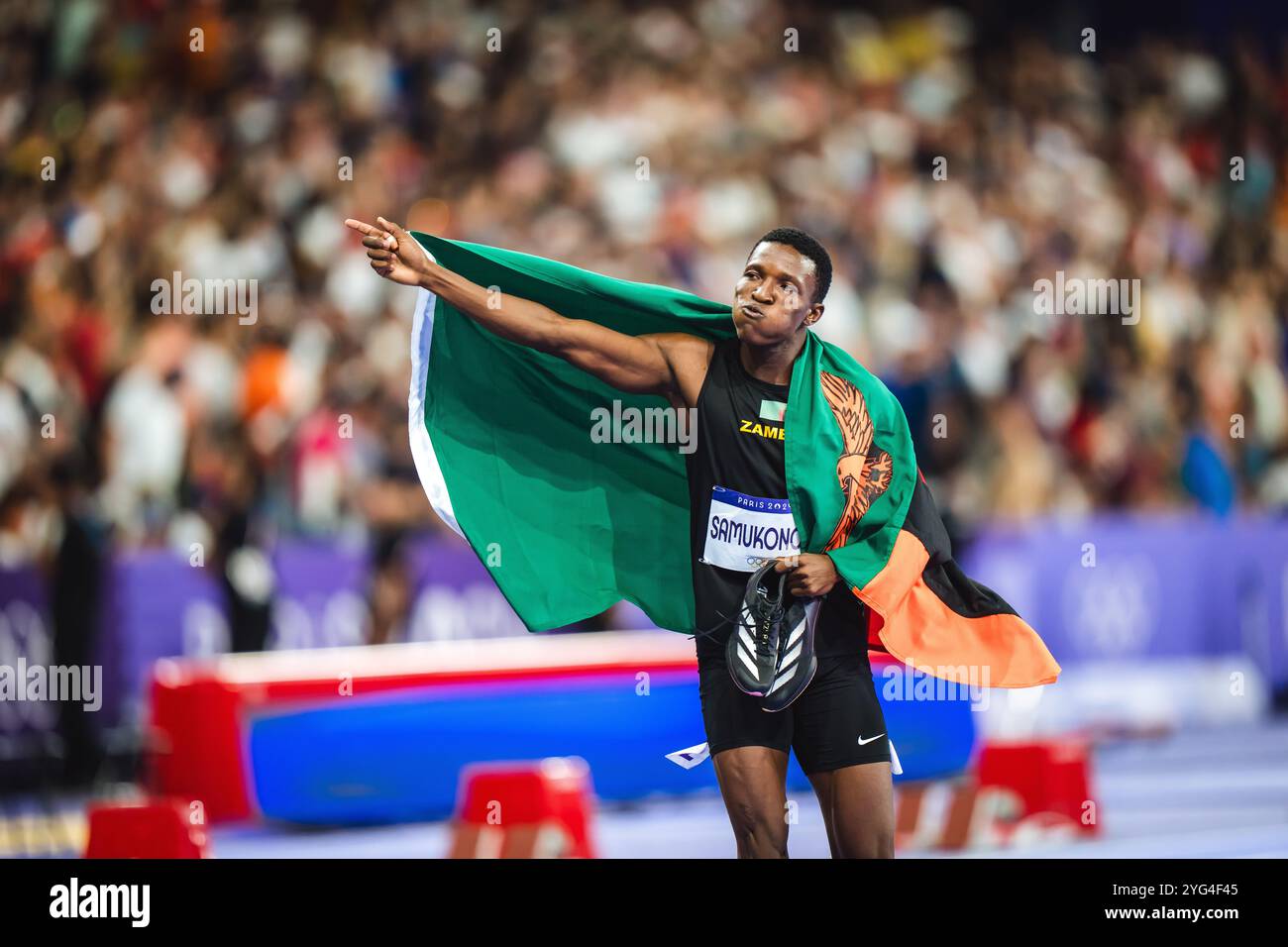 Muzala Samukonga celebrating her victory with her country's flag at the ...