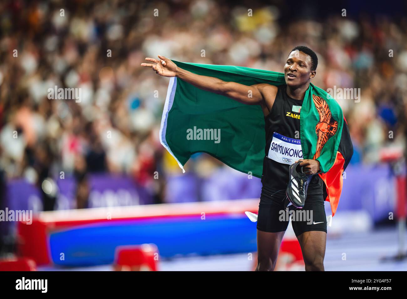 Muzala Samukonga celebrating her victory with her country's flag at the ...
