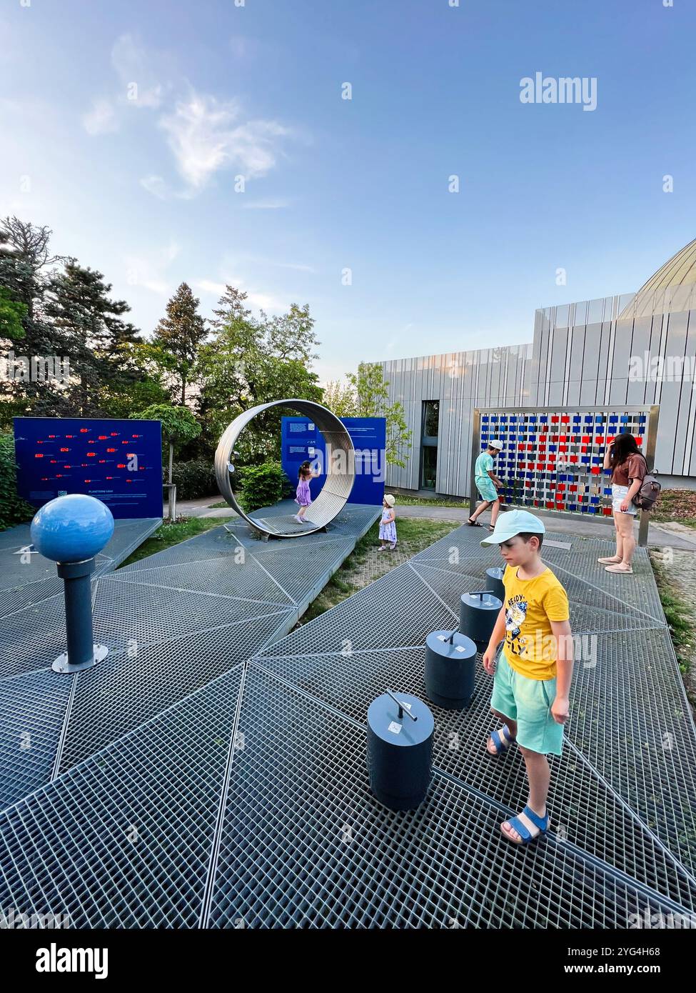 Children are enjoying interactive science exhibits in a modern outdoor ...