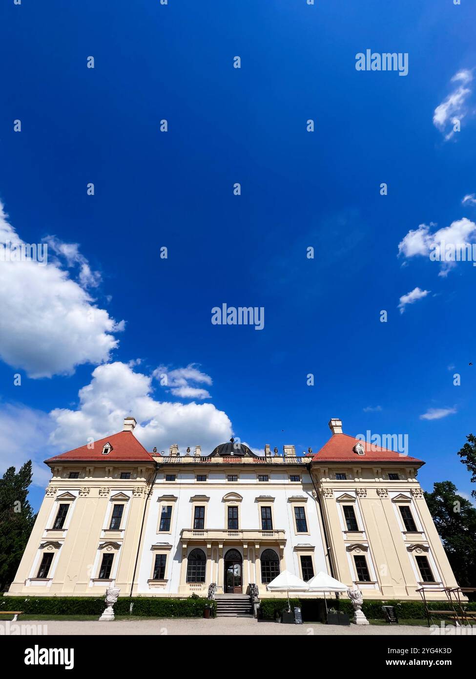 A stunning historic mansion with red roofs stands grandly under a ...