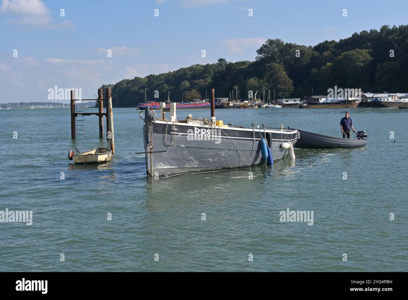 young boatman moving restoration project of vintage wooden boat, pin ...