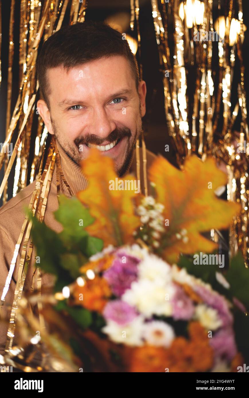 Handsome guy holding flowers hi-res stock photography and images - Alamy