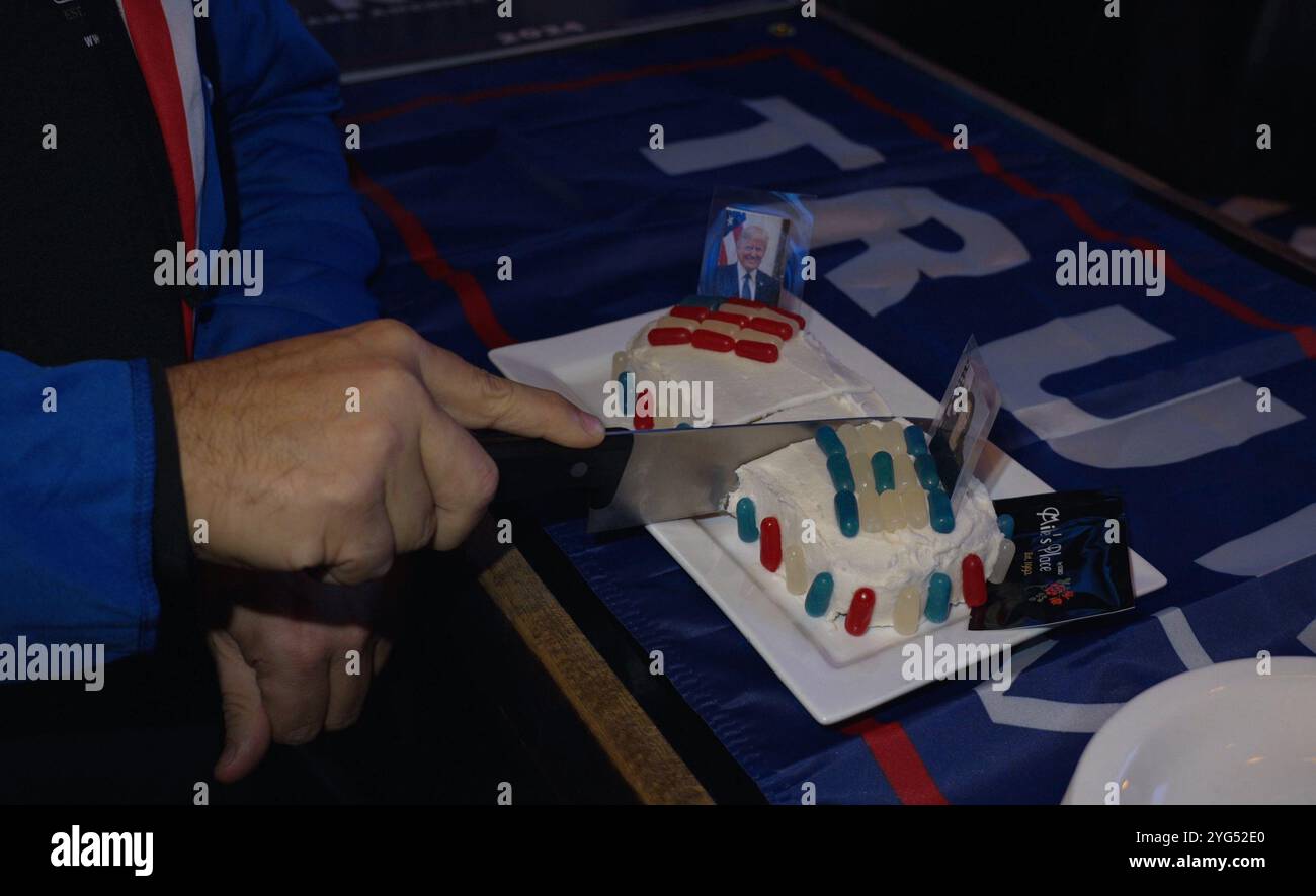 JERUSALEM - NOVEMBER 6: A person cuts a cake with photos of Republican ...