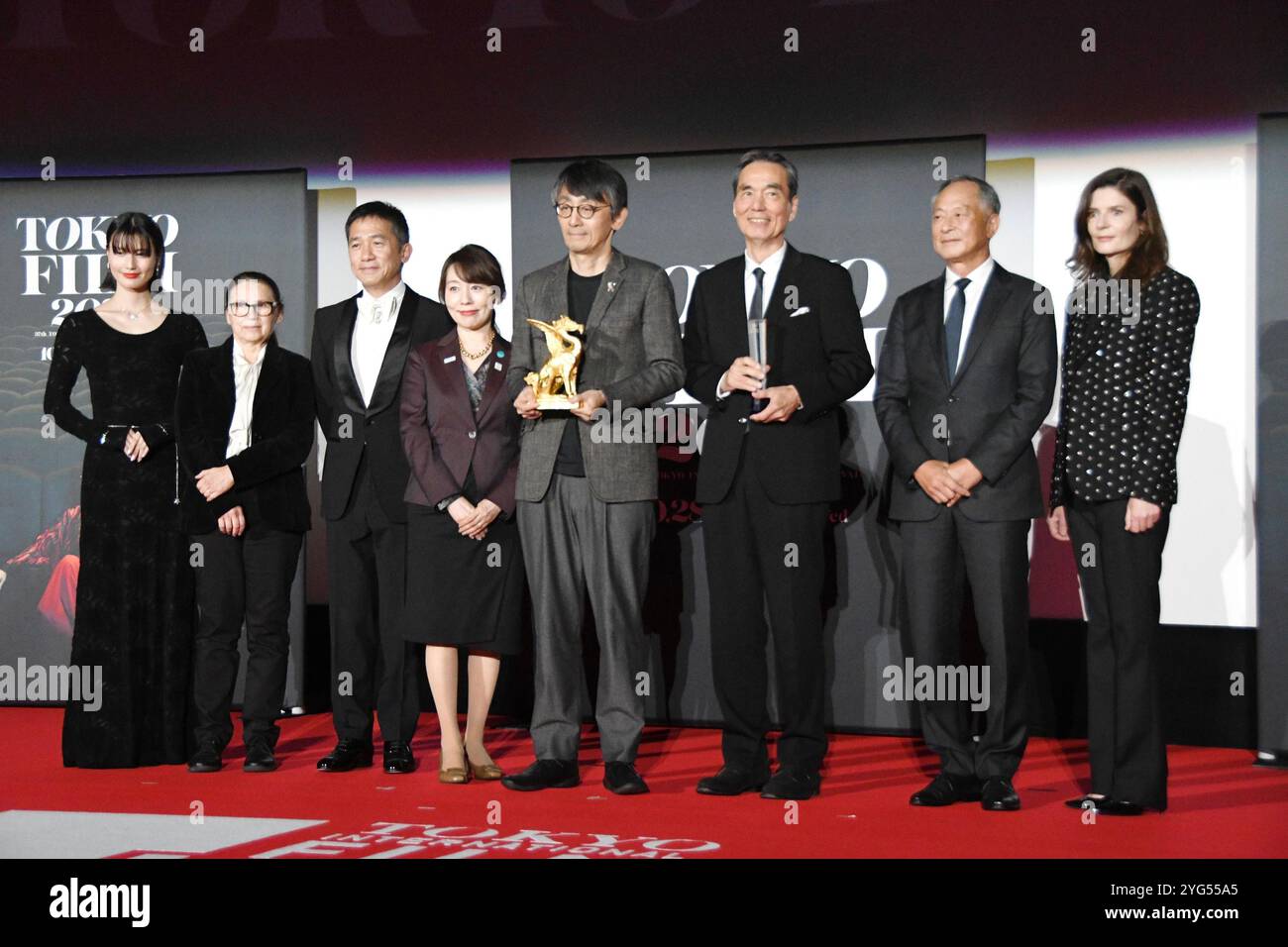 Japanese film director Daihachi Yoshida (4th from R) and actor Kyozo Nagatsuka (3rd from R) pose ...