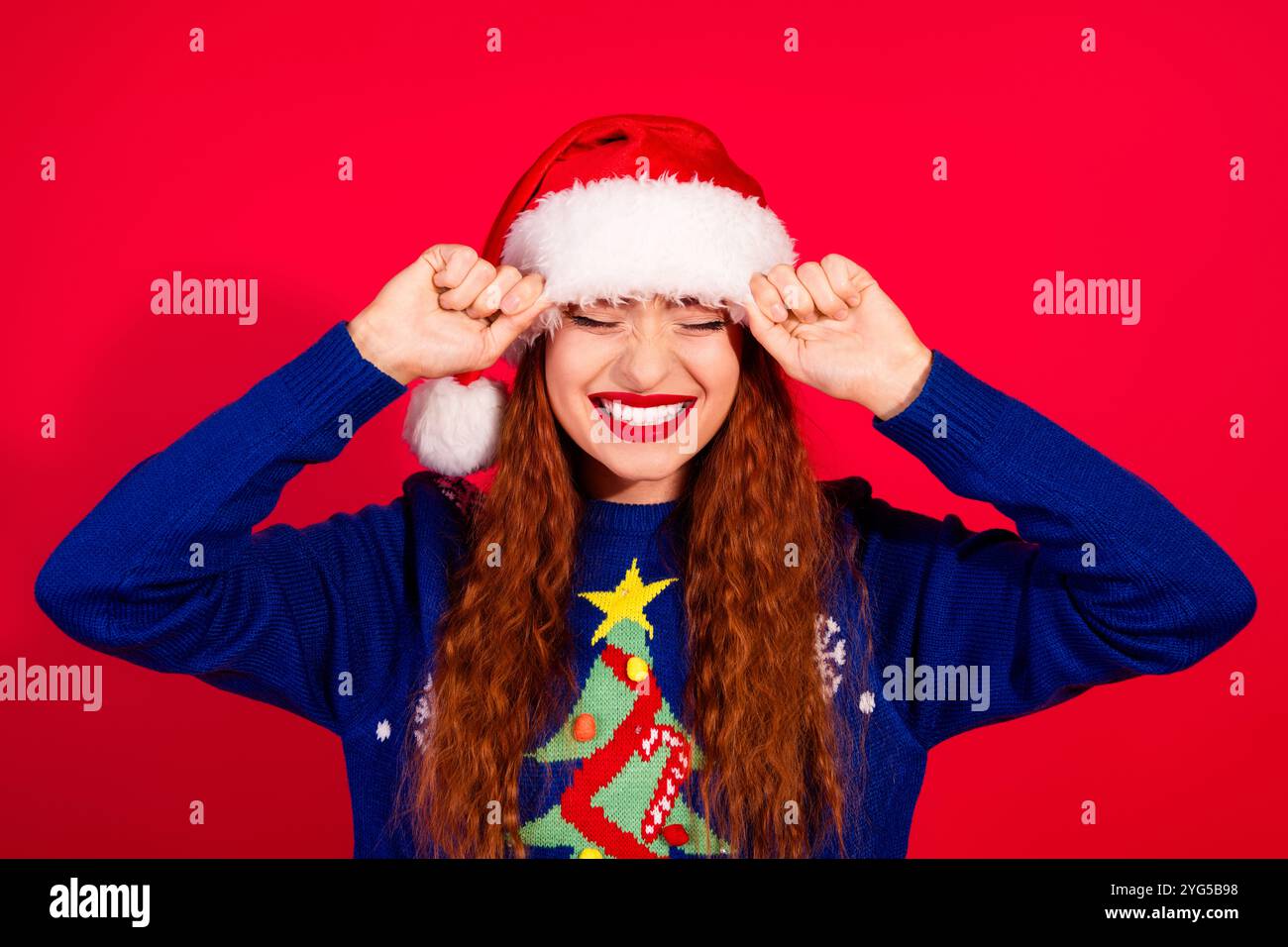 Photo of pretty young girl pull hat santa claus wear trendy blue ...