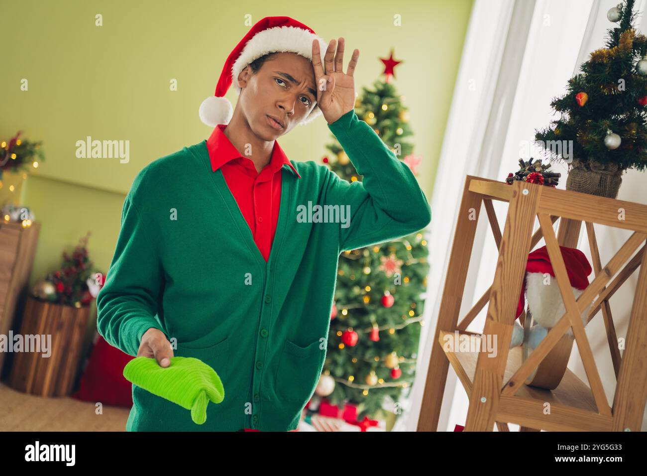 Photo of tired stressed guy wear green jumper doing cleaning praparing ...