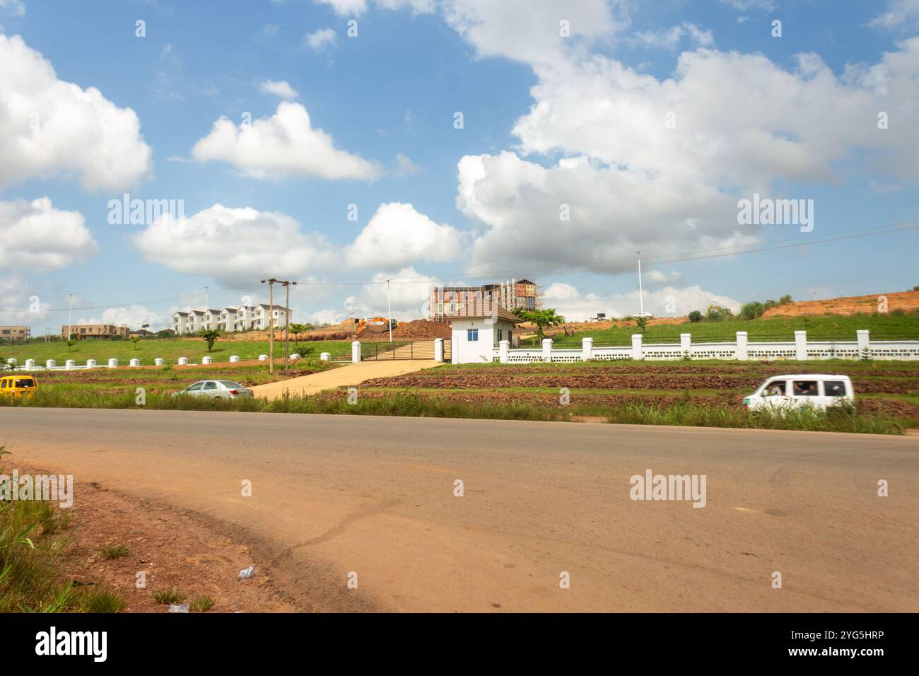 Urban construction site with excavator and building scaffolding under a ...