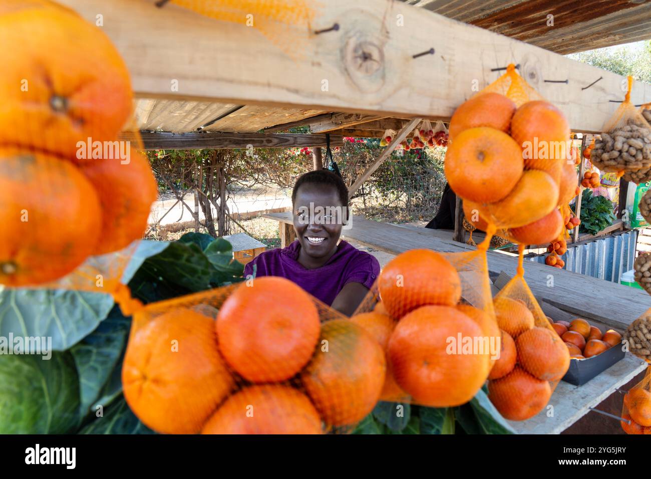 Happy African street vendor hawker village , woman with short hair ...