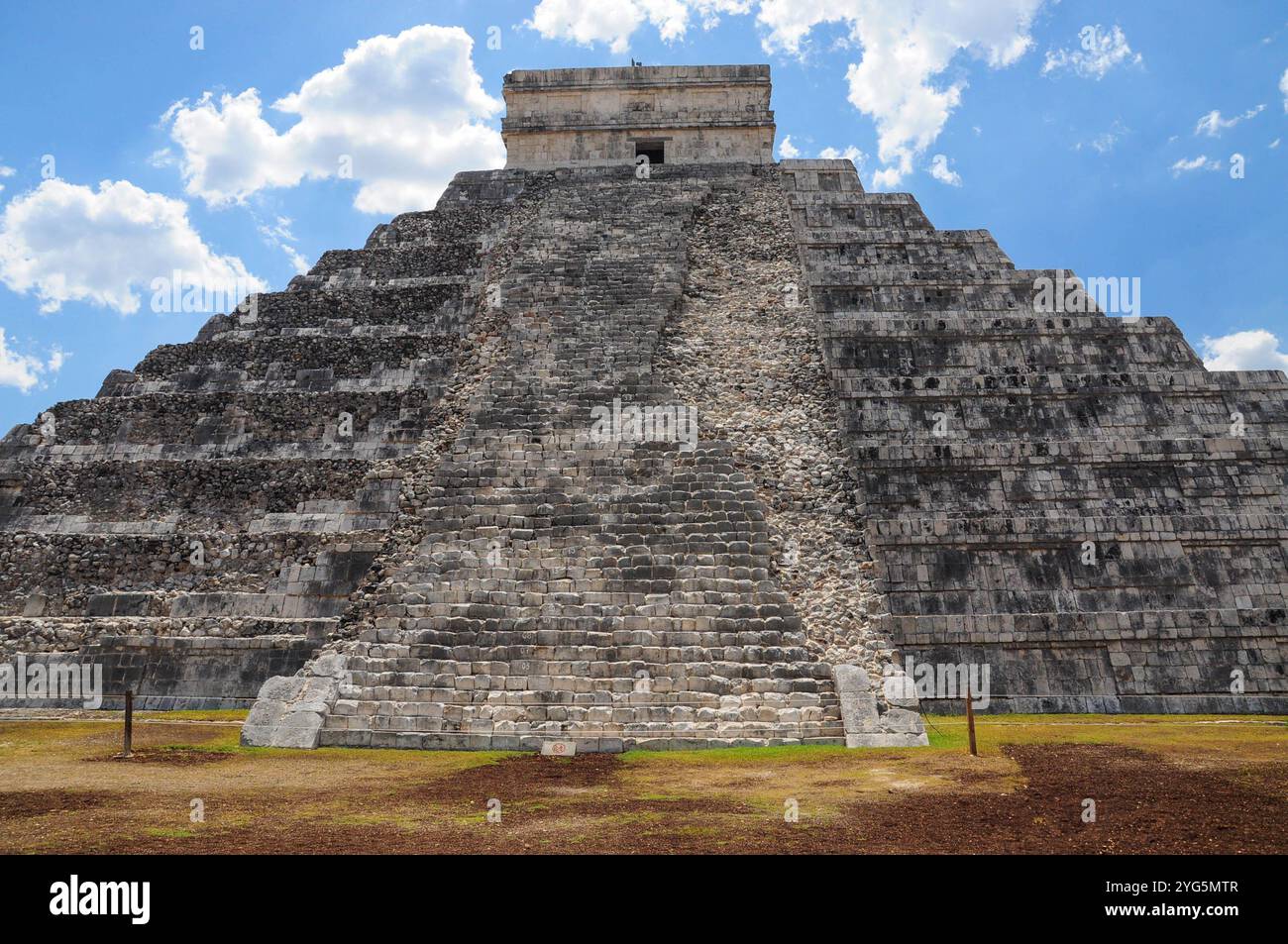 Majestic Chichen Itza pyramid under blue sky, highlighting ancient ...