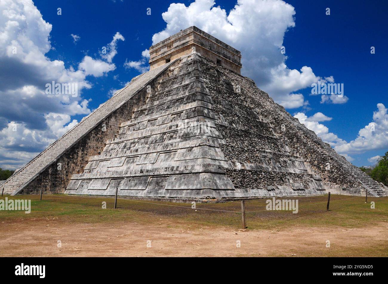 Majestic view of the ancient Pyramid of Chichen Itza under a clear blue ...