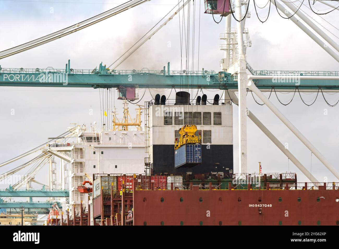 Miami, Florida, USA - 1 December 2023: Crane lifting a shipping ...