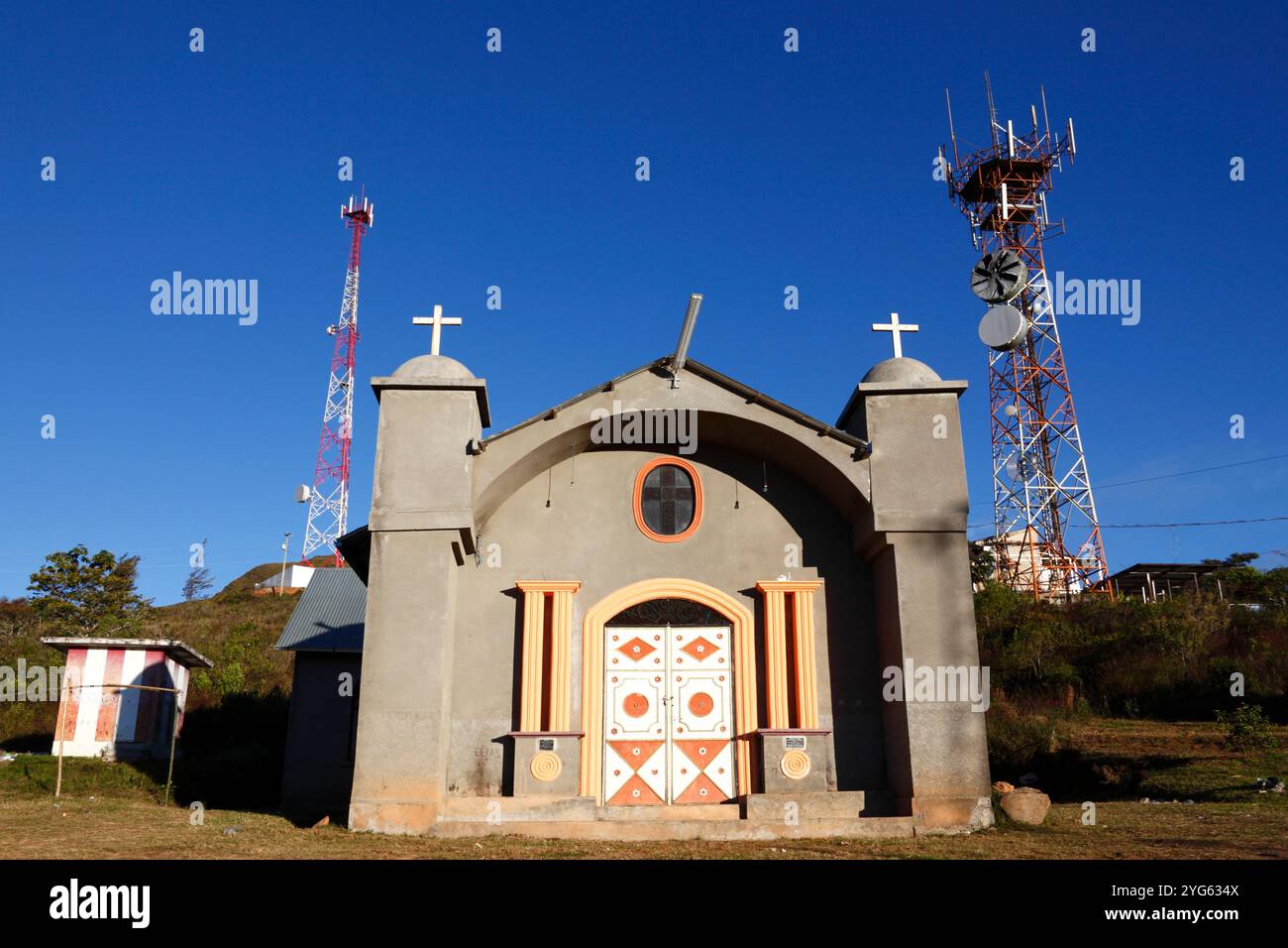 Mobile phone / radio masts and modern concrete Calvario church, Coroico, Yungas region, Bolivia ...