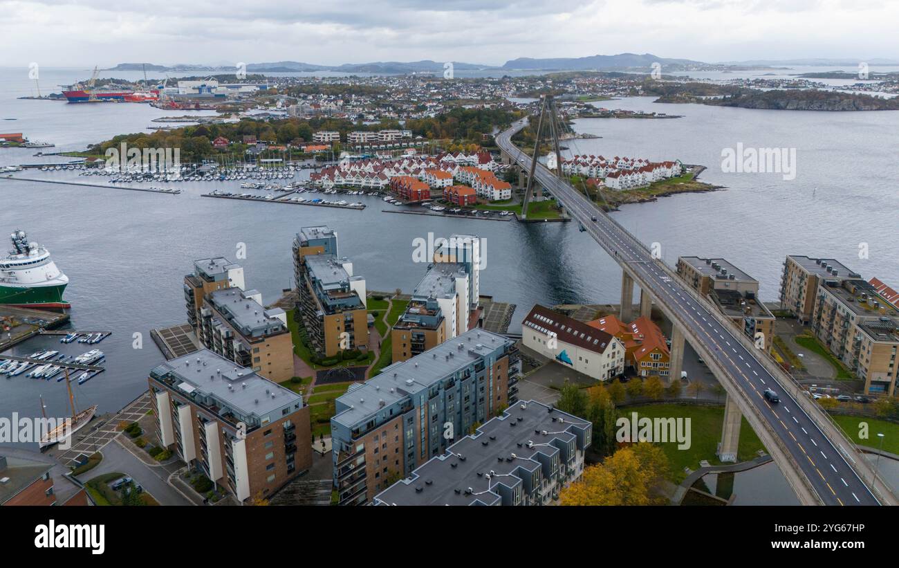 Aerial view of a coastal city with a bridge connecting two land masses ...