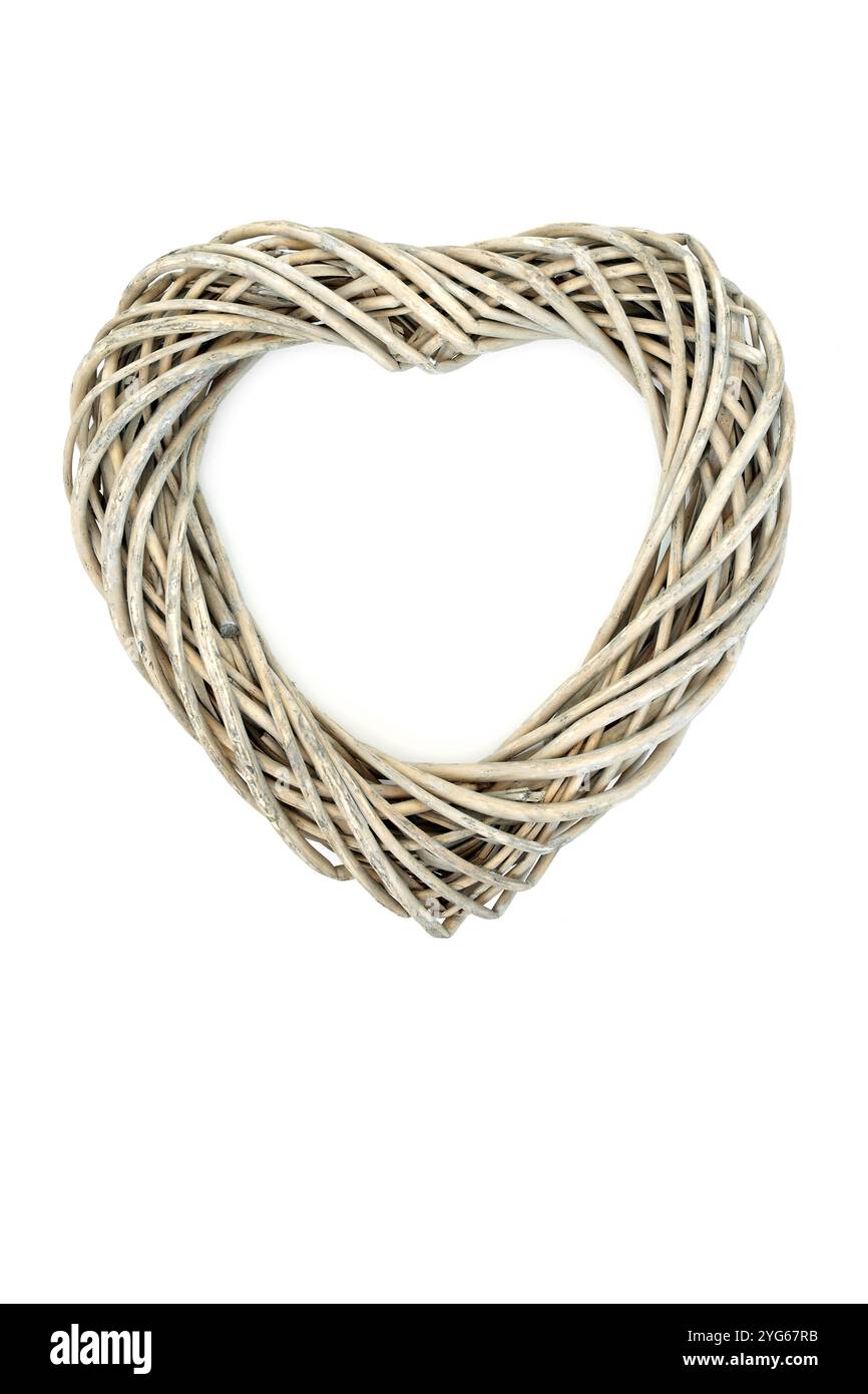 Heart shape wicker woven wreath on white background. Romantic symbol of ...
