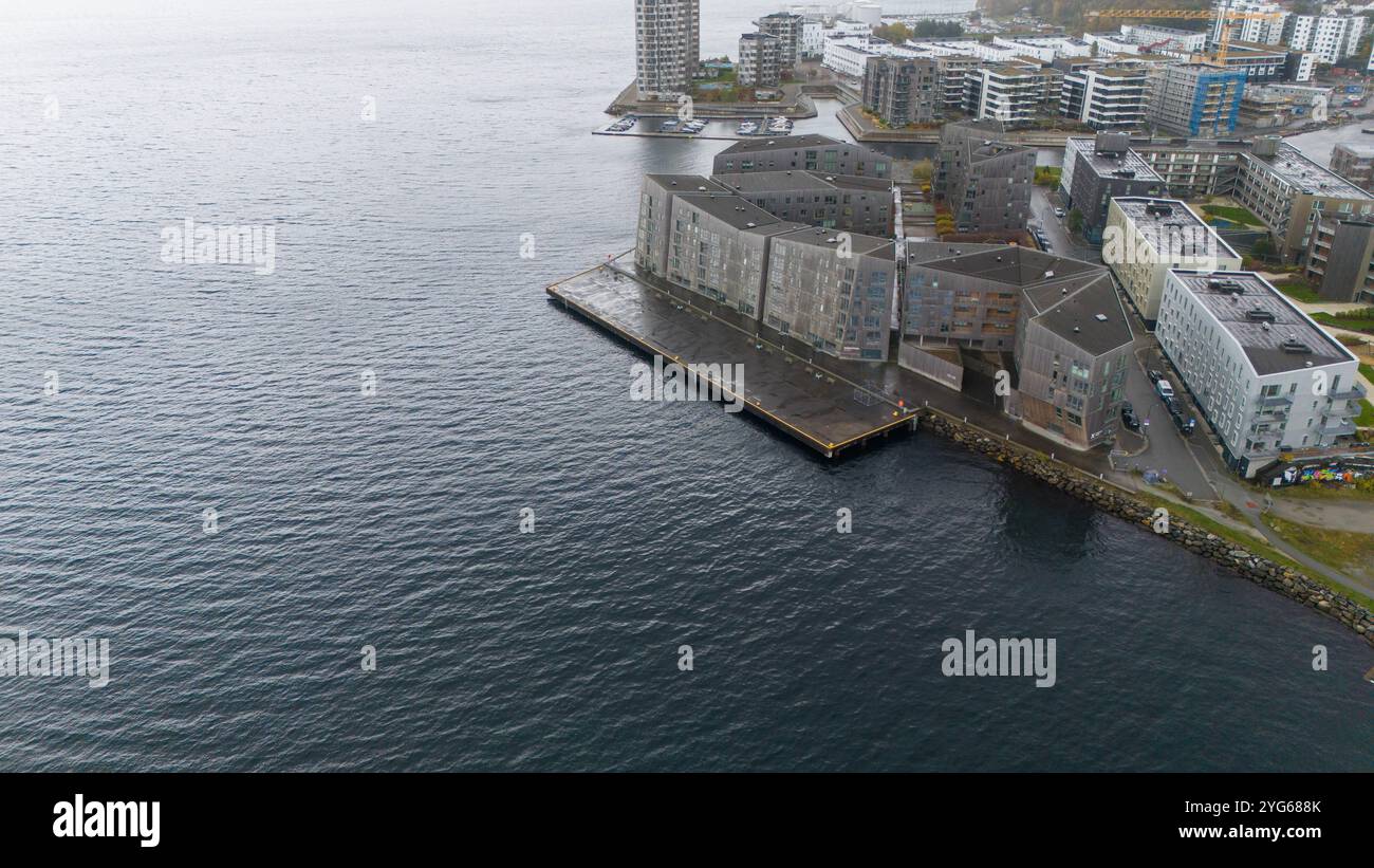 Aerial view of modern waterfront apartment buildings by a calm sea ...
