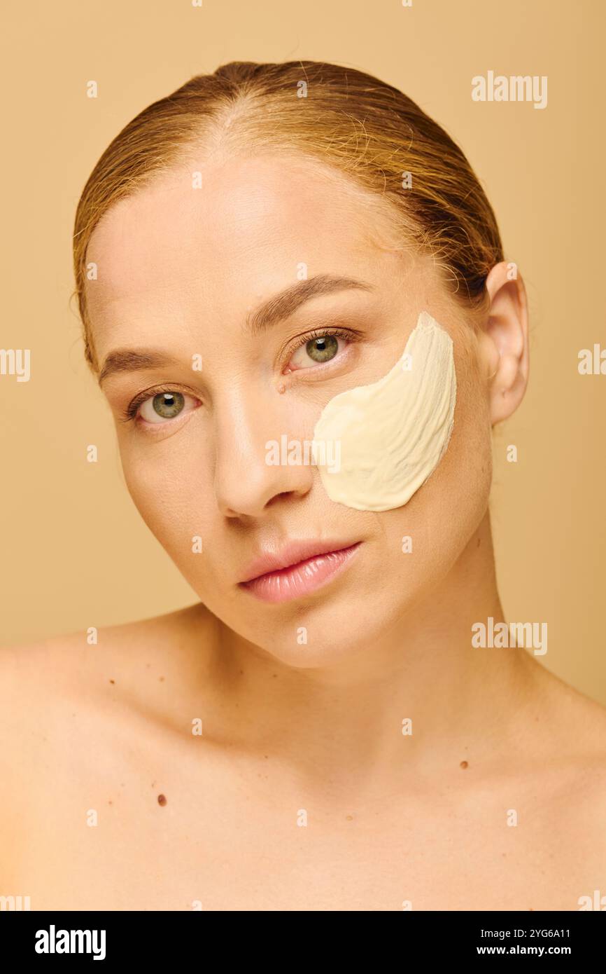 A young beautiful plus size woman relaxes while applying a creamy ...