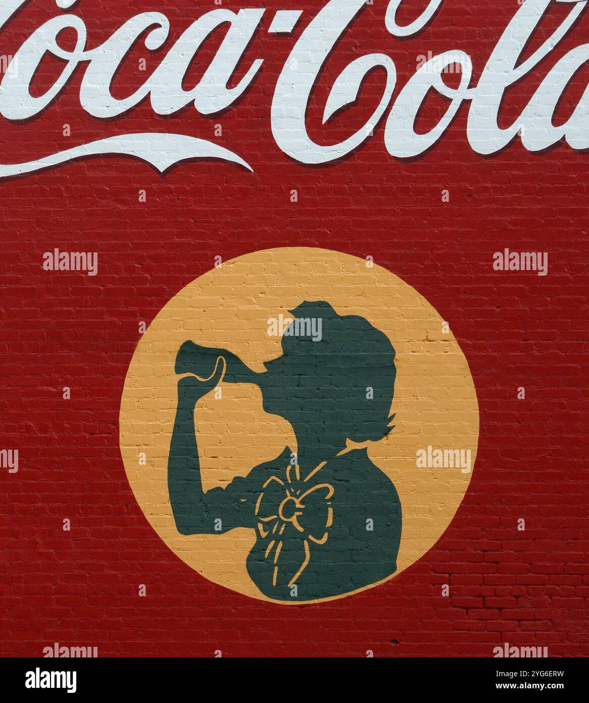 A Coca-Cola advertisement painted on the side of a brick building in ...