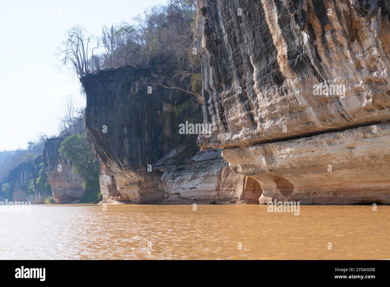 Limestone cliffs with unique erosion patterns and lush vegetation ...