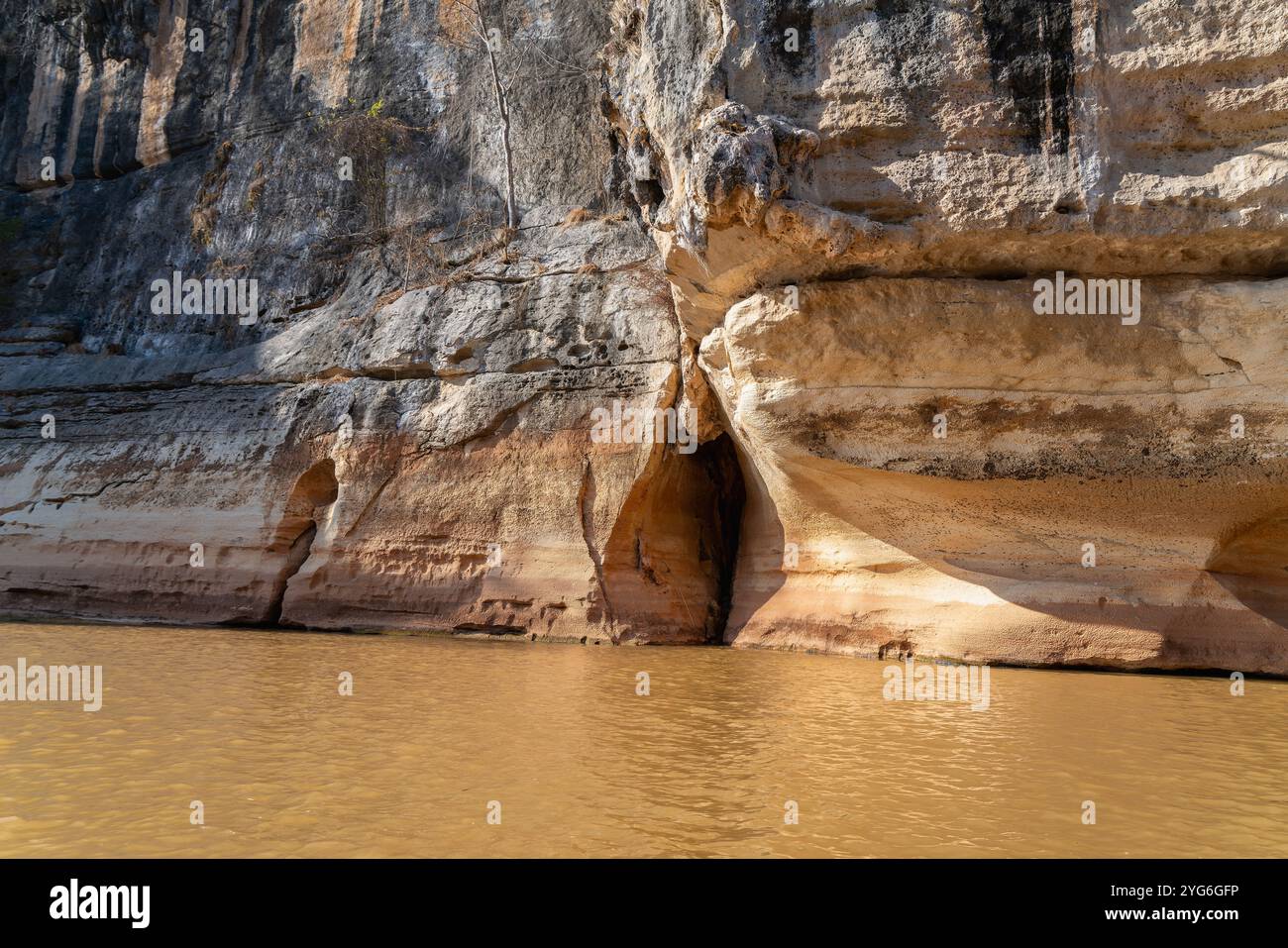 Limestone cliffs with unique erosion patterns and lush vegetation ...