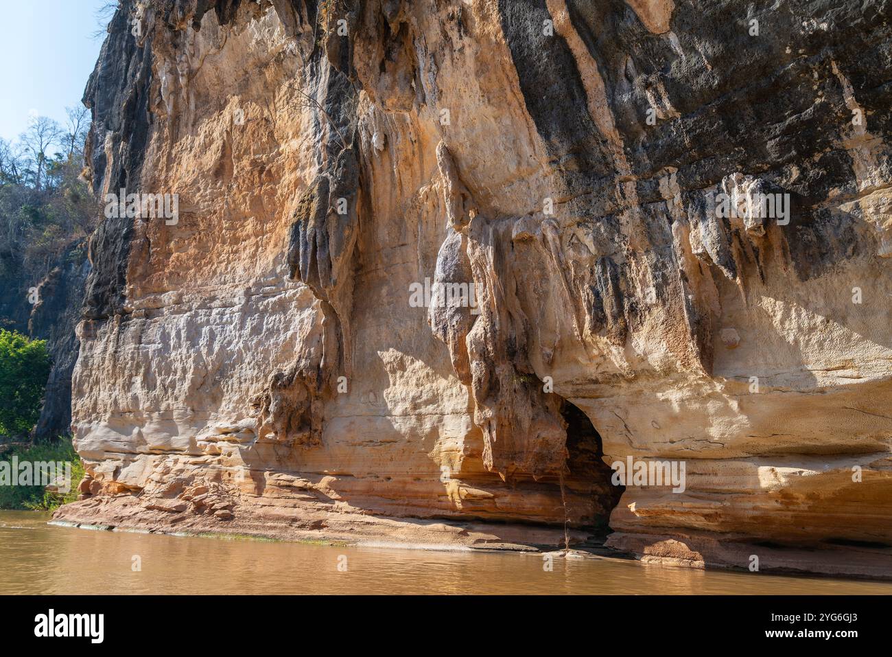 Limestone cliffs with unique erosion patterns and lush vegetation ...
