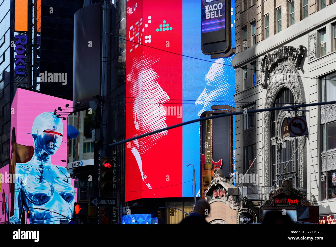 Images of Donald Trump and Kamala Harris are displayed on screens in ...