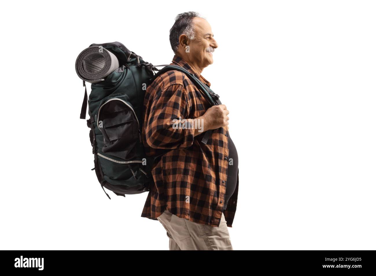 Mature hiker carrying a backpack and walking isolated on white ...