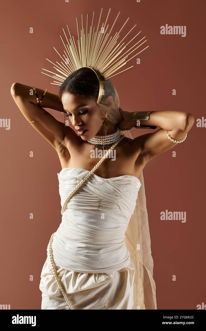 An elegant African American woman poses in a pearl-embellished white ...