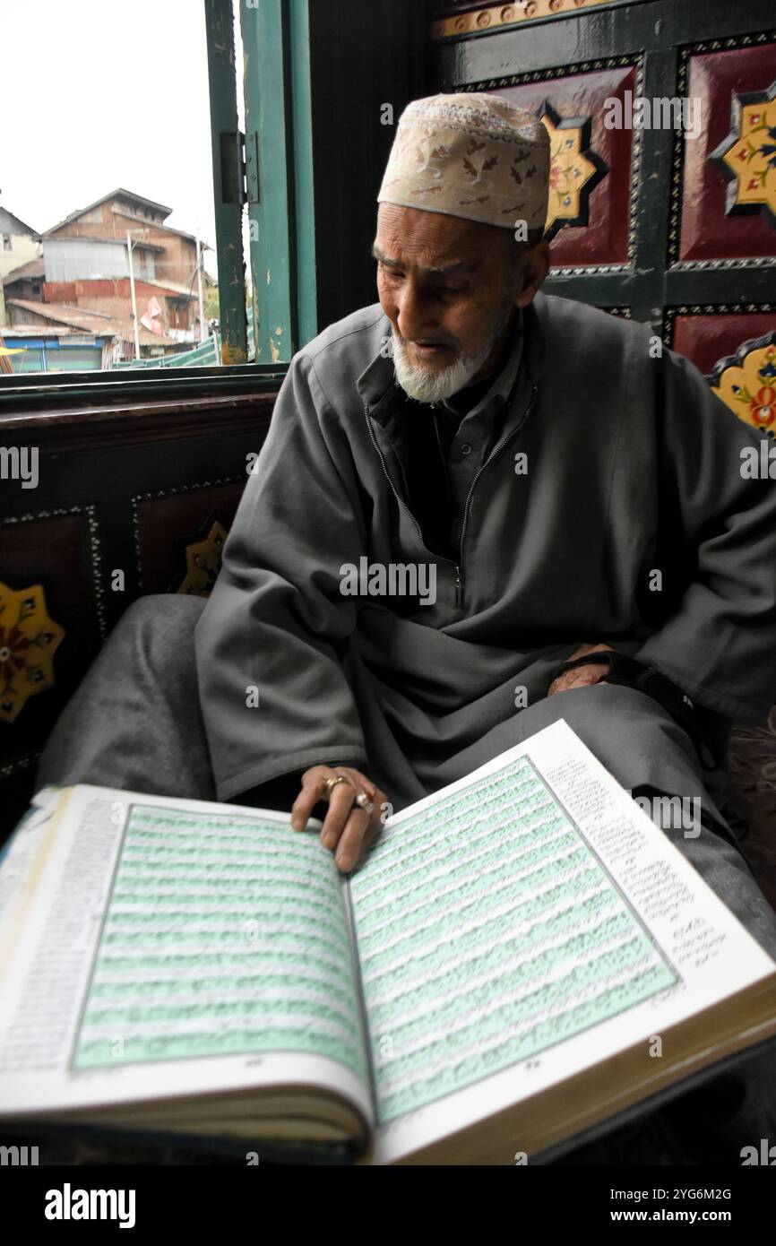 A Kashmiri man reads Holy Quran on the first day of Ramadan inside a ...