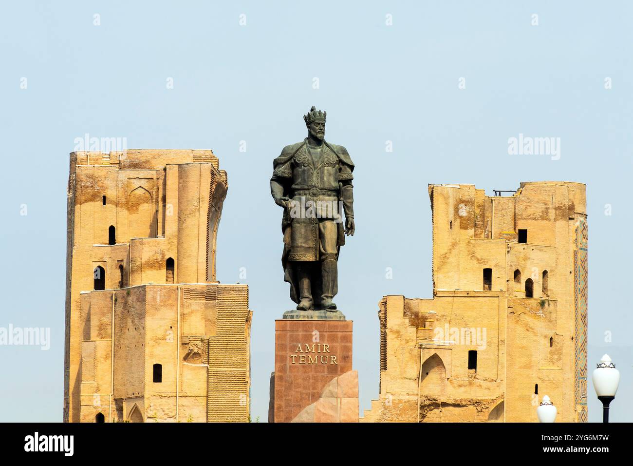 A monumental statue of Amir Timur stands in front of the ruins of the ...