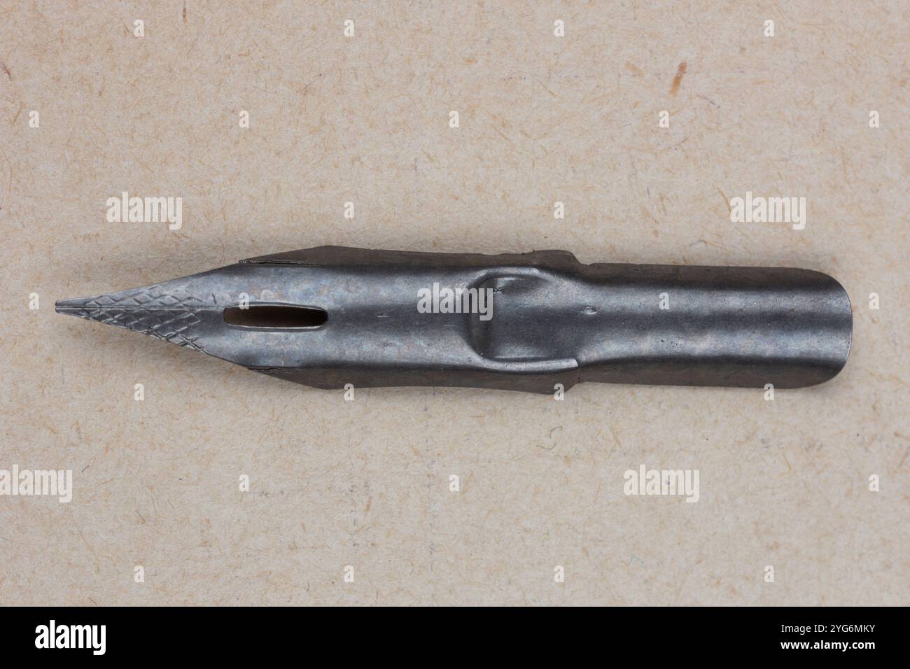 Metal nibs on an antique textured paper background Stock Photo - Alamy